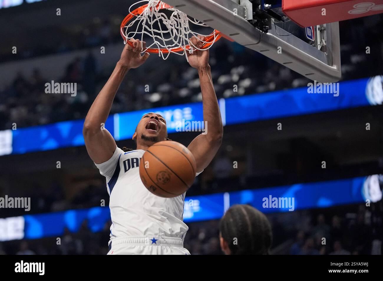 Dallas Mavericks center Moses Brown dunks against Charlotte Hornets guard Nick Smith Jr. during ...