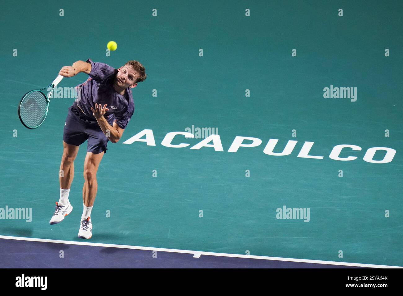 David Goffin of Belgium serves to Brandon Nakashima of the U.S. during ...