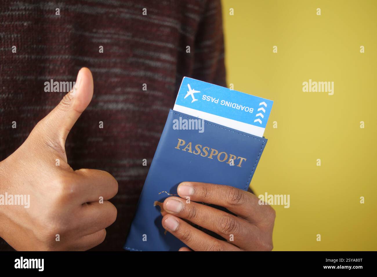 Preparing for travel with passport and boarding pass in hand Stock ...