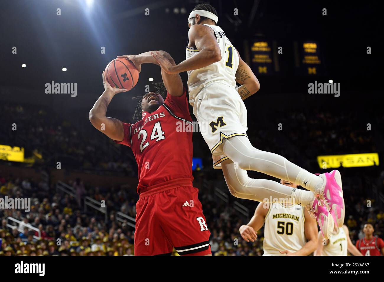 Rutgers center Lathan Sommerville, left, is fouled on the shot attempt ...