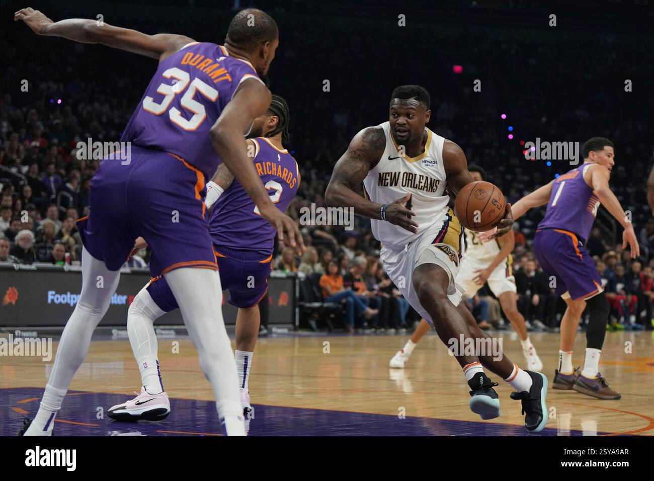 New Orleans Pelicans forward Zion Williamson (1) drives on Phoenix Suns center Nick Richards (2 ...