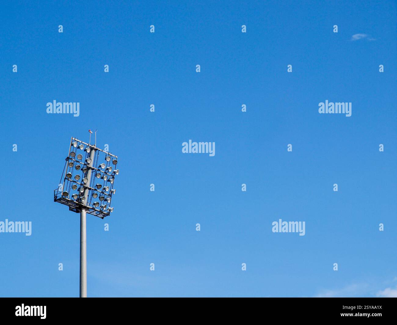 Flood lights with steel pole against a vibrant blue sky Stock Photo - Alamy