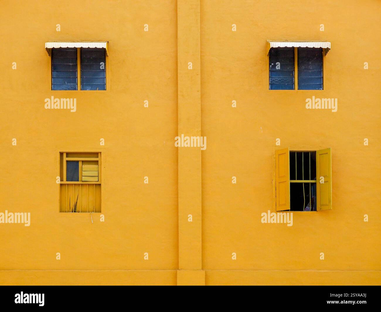 Yellow walls with two glass windows, a wooden window and a sealed ...
