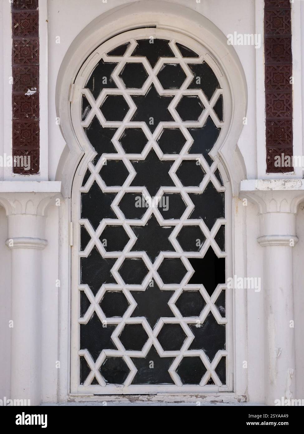 Geometric star shaped glass windows with white walls Stock Photo - Alamy