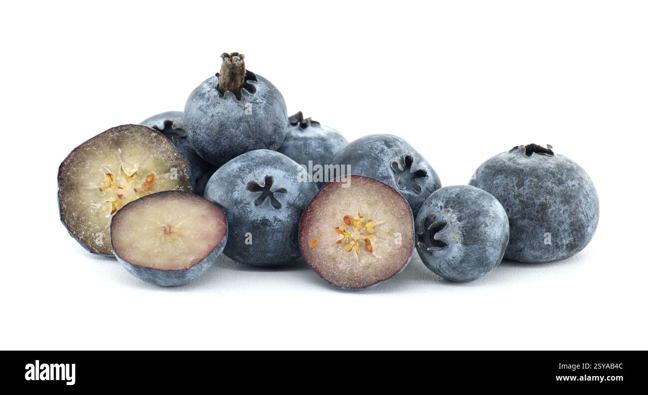 Pile of fresh blueberries, some halved to reveal the inside, on a clean ...