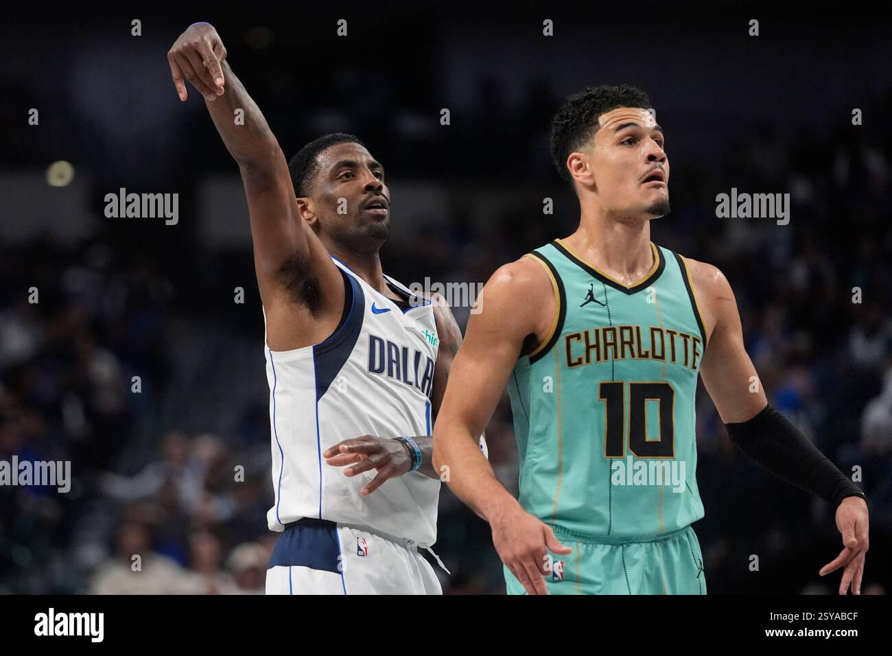 Dallas Mavericks guard Kyrie Irving (11) watches his shot against Charlotte Hornets guard Josh ...