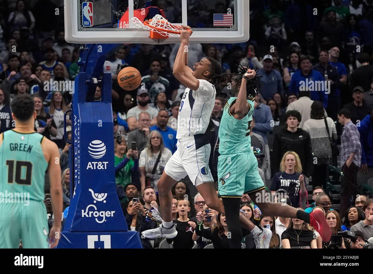 Dallas Mavericks center Moses Brown (9) slam dunks past Charlotte Hornets center Mark Williams ...