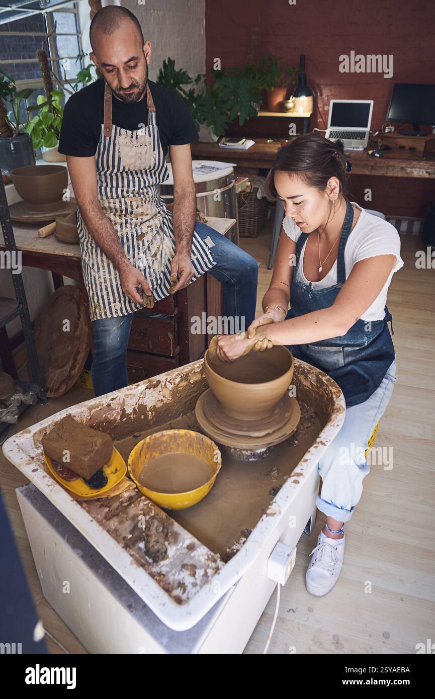 Teamwork, pottery wheel and people in workshop, clay and manufacturing ...
