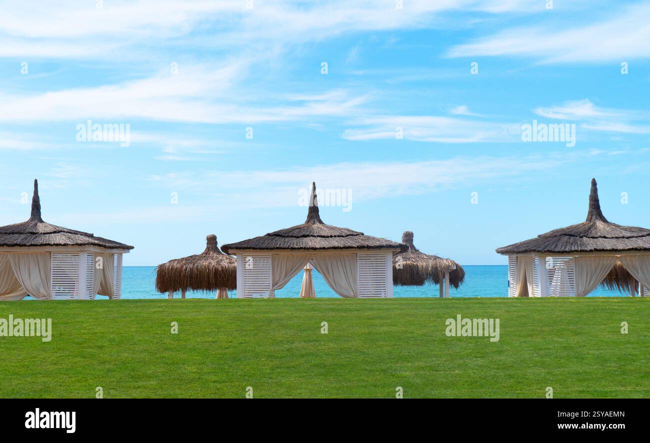 White beach canopies at sunset. Luxury beach tents at luxurious beach ...