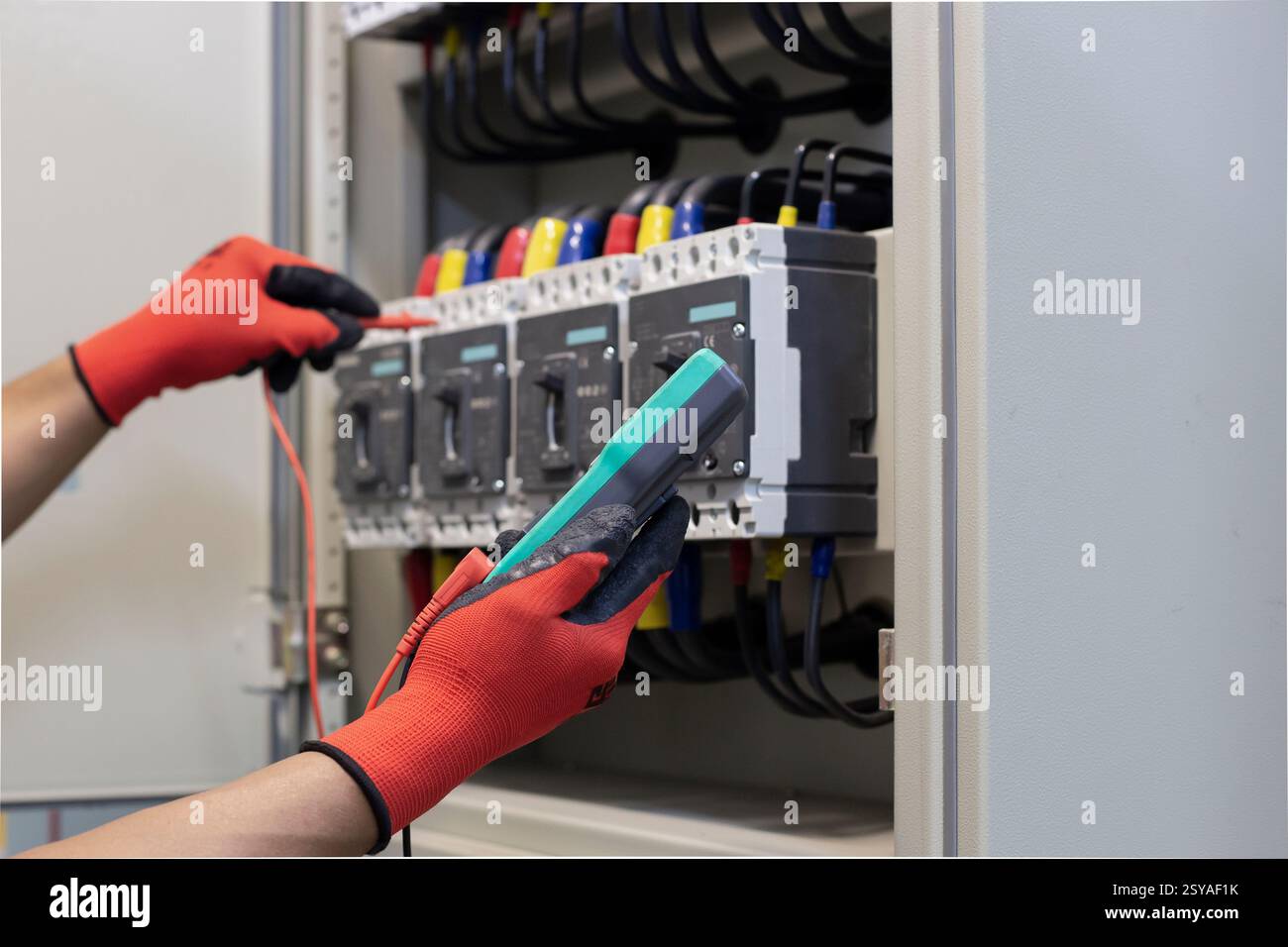 Electrical engineer checks the operation of the electrical control ...