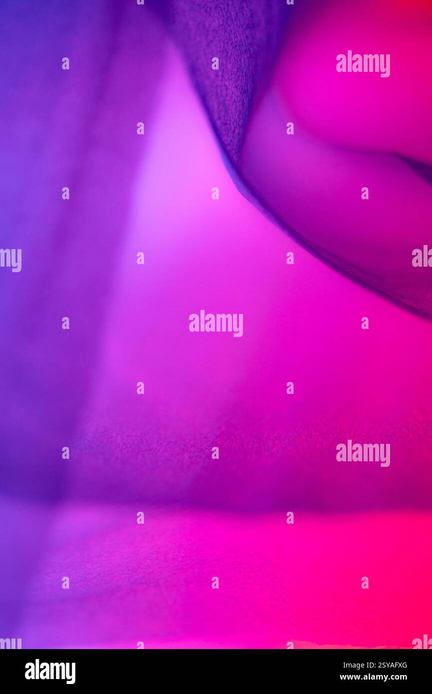 Soft fabric in shades of blue and purple flows gently, illuminated by ...