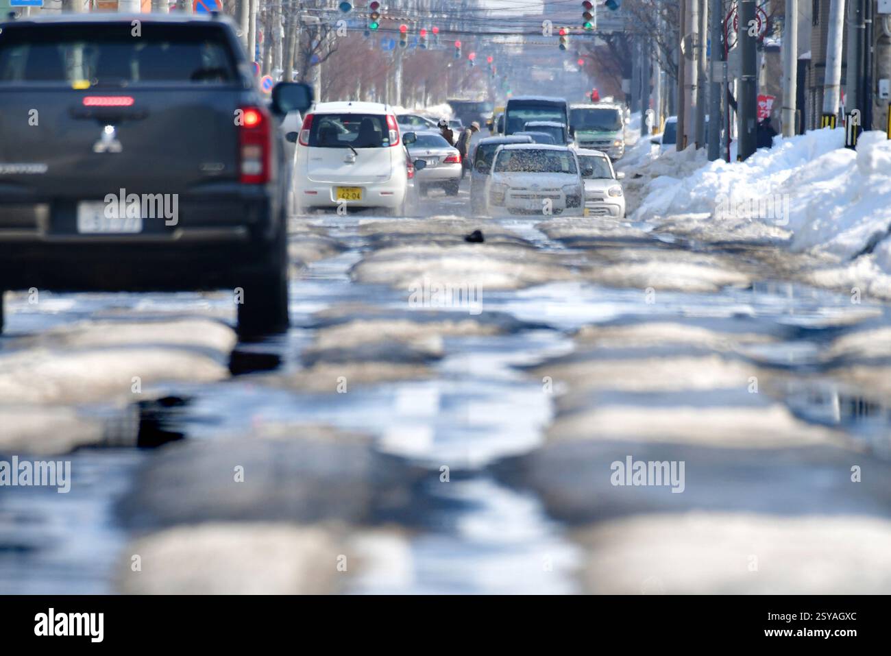Road in bad condition as snow melts due to rising temperatures is seen ...