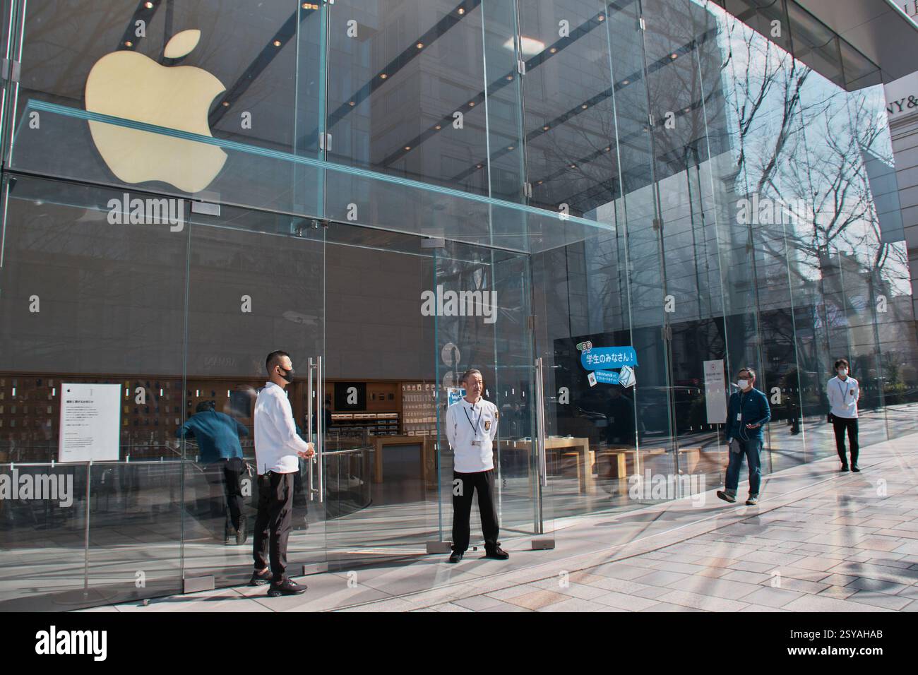Staff members stand in front of their store during the launch day at ...