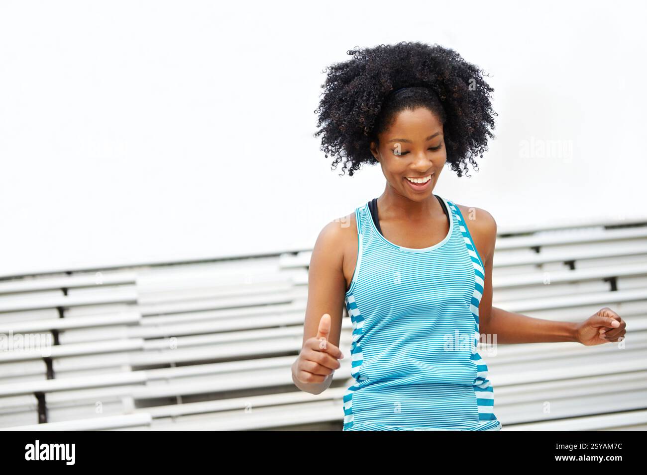 Smile, running and stairs with black woman in stadium for sports ...