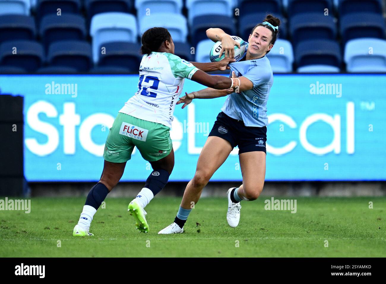Maya Stewart of the Waratahs is tackled by Josivini Naihamu of the Drua ...