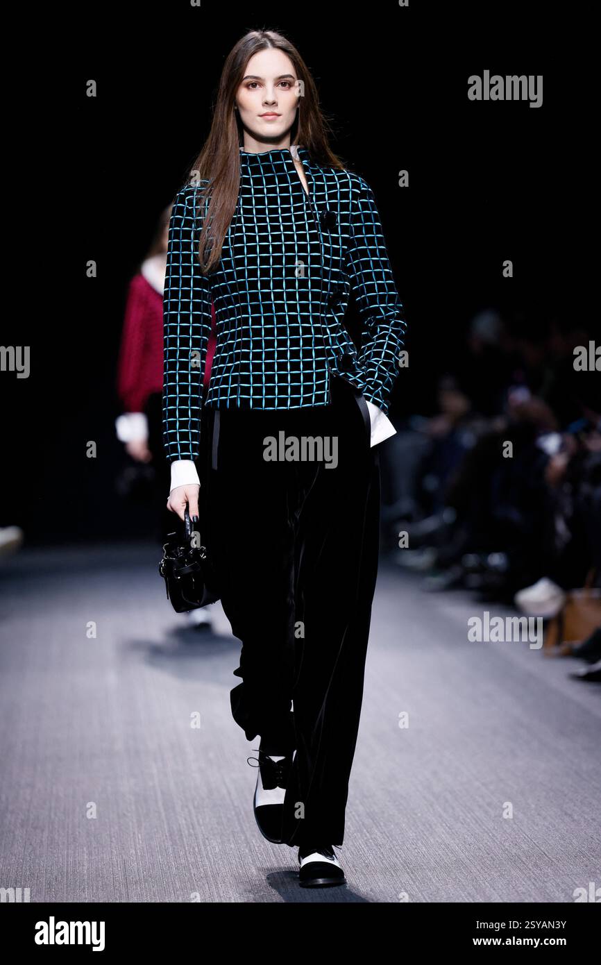 Milan, Italy. 27th Feb, 2025. A model walks the runway of Emporio ...