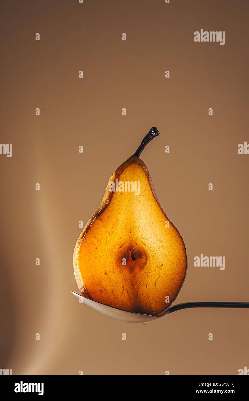 Pear in syrup. Restaurant dish. Studio photography on a beige ...