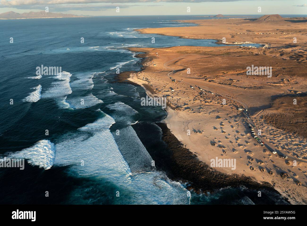 High-angle shot capturing the unique wave patterns and the sandy shore ...