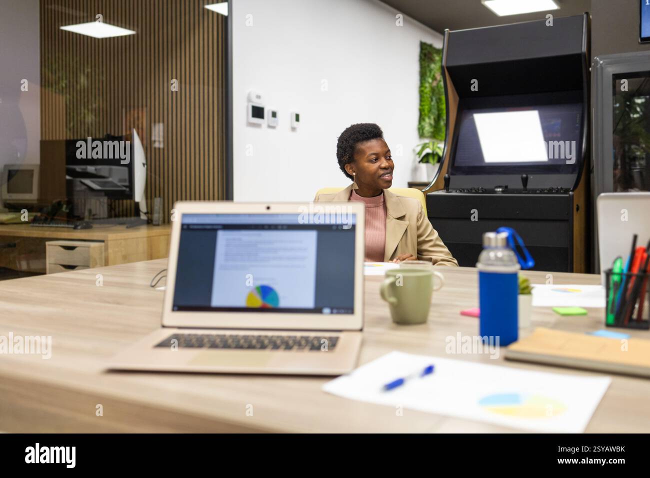 Modern office with a professional ambiance. A black woman is seated at ...