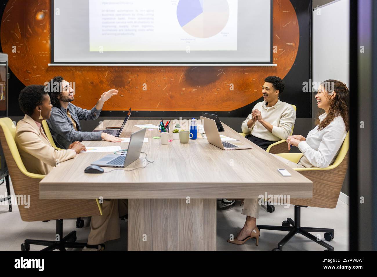 A diverse team collaborates in a modern office setting. They're engaged ...