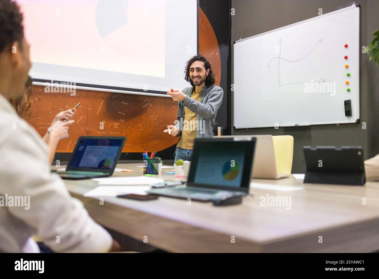 A dynamic office setting with a diverse team engaged in a presentation ...