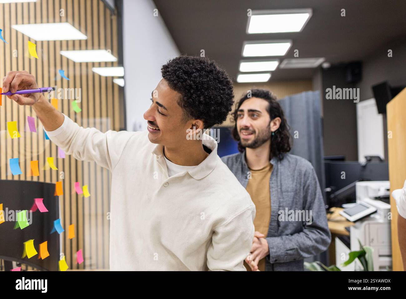 Two young professionals engage in a creative brainstorming session at ...