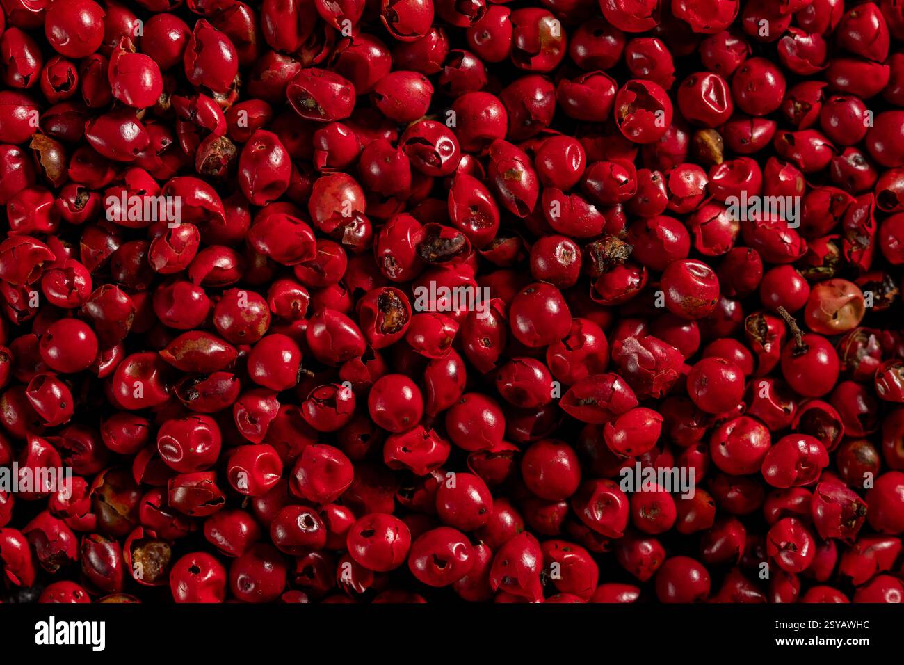 Densely packed red peppercorns with a vibrant color and some with ...