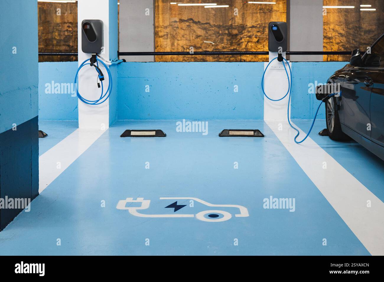 Modern electric vehicle charging station in a blue-themed garage ...