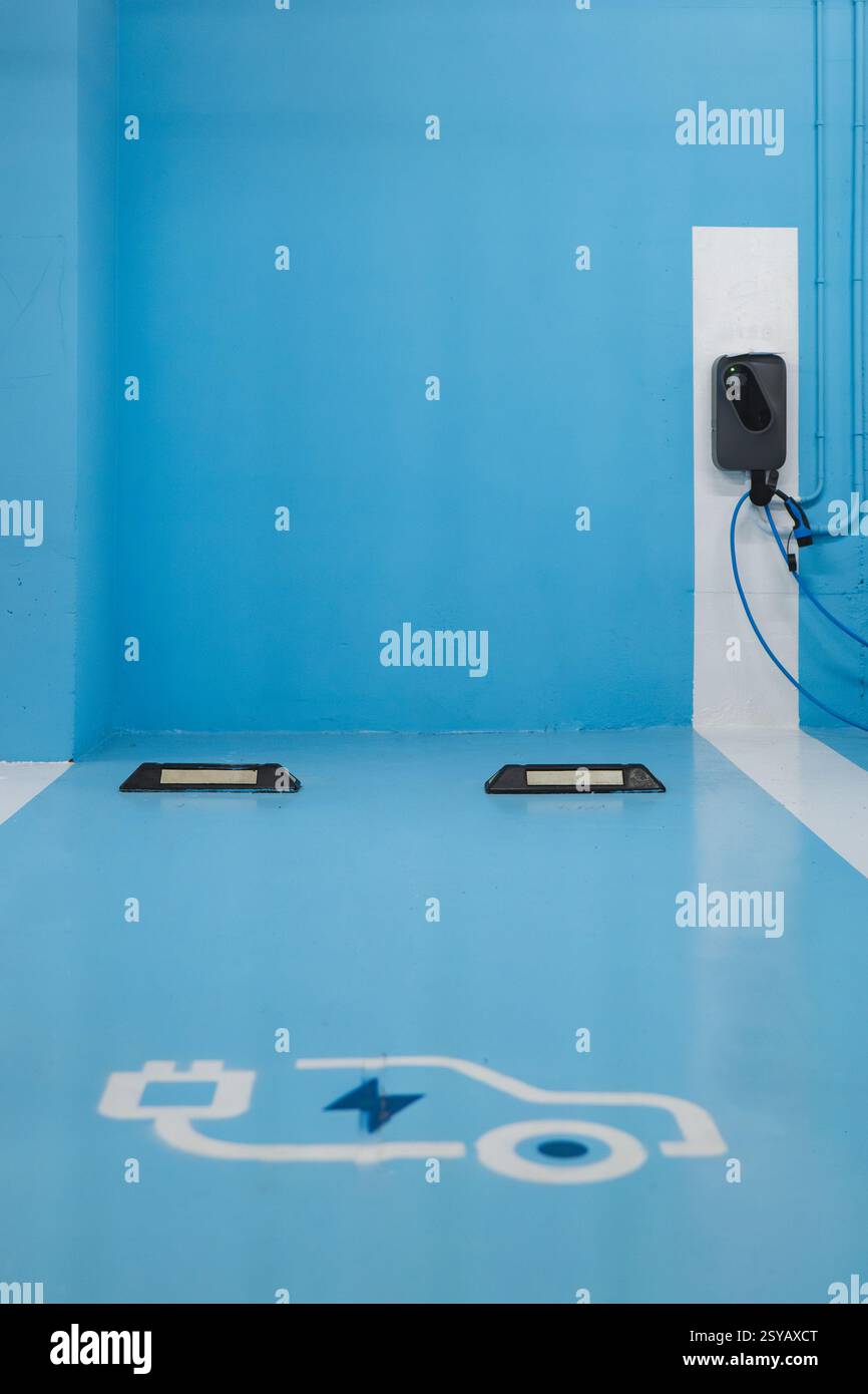 A electric car charging station, featuring a charger mounted on a blue ...