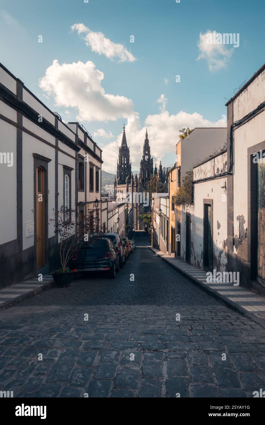 A calm cobblestone street lined with traditional houses leads to the ...