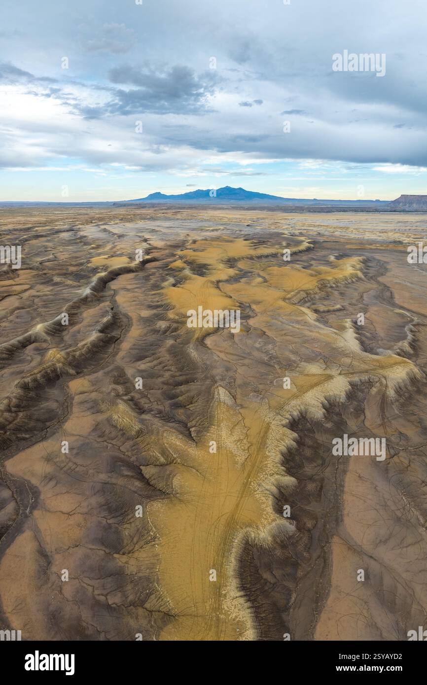 Aerial view of an expansive desert terrain featuring rugged formations ...