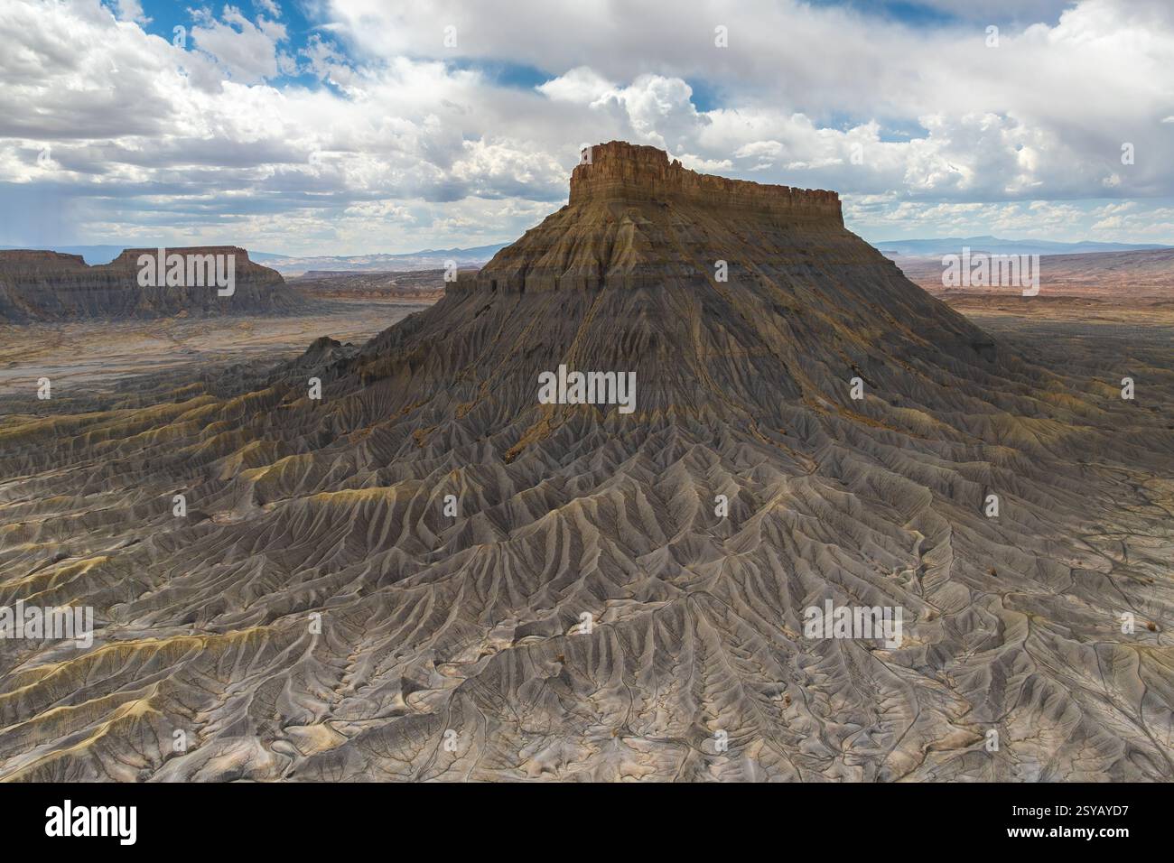 A striking aerial view of a weathered plateau with deep ridges and a ...