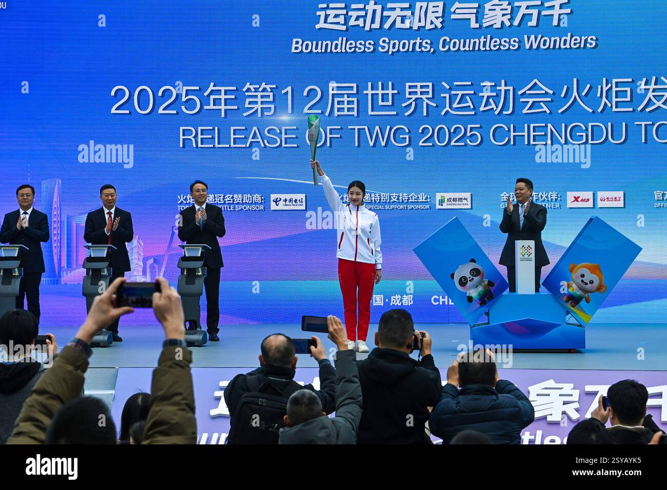 Chengdu,China.27th February 2025. An athlete showcases the torch of the ...