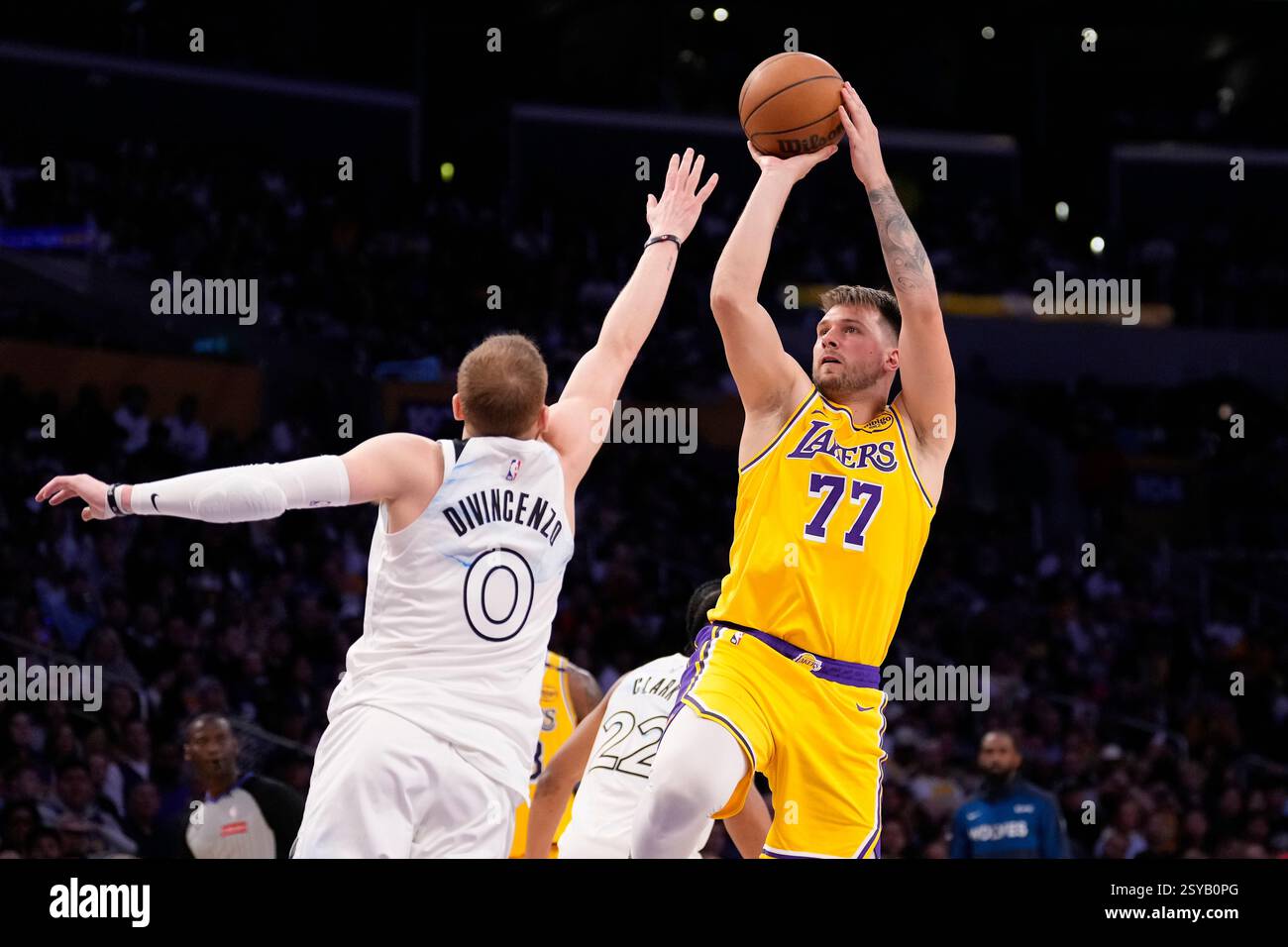 Los Angeles Lakers guard Luka Doncic, right, shoots as Minnesota ...