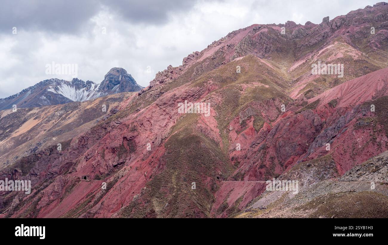 Majestic red-hued mountains of the Peruvian Andes under a cloudy sky ...