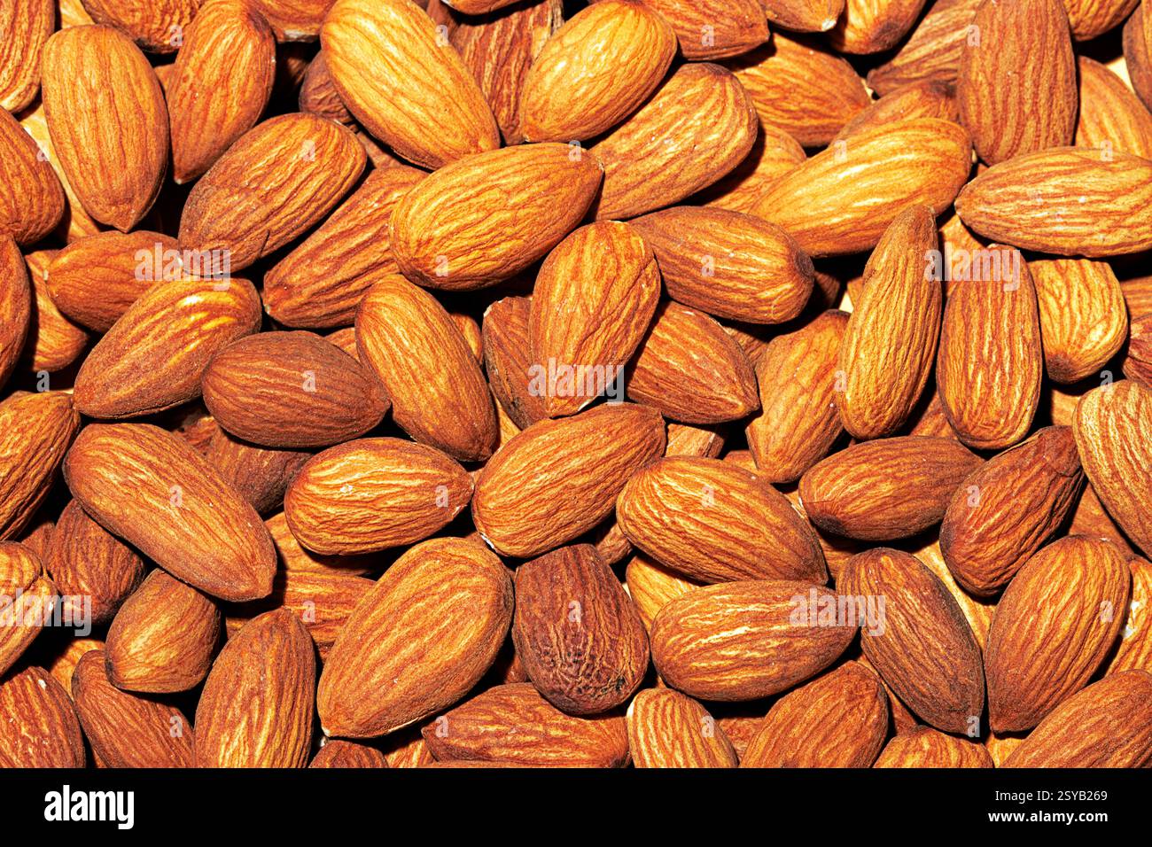 This image captures a detailed close-up of raw almonds with visible ...