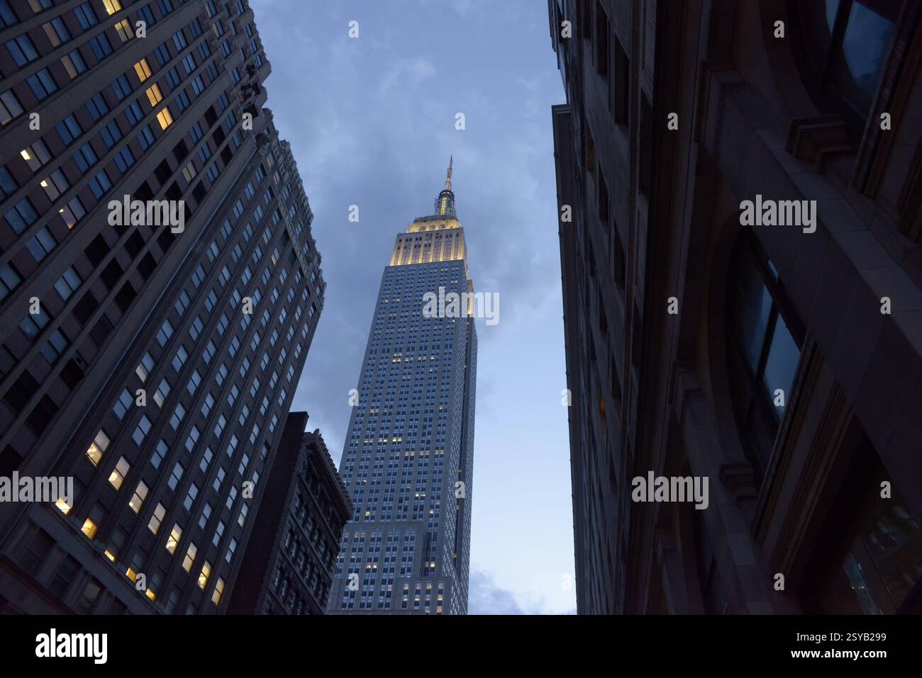 Low angle of the Empire State Building towers majestically between ...