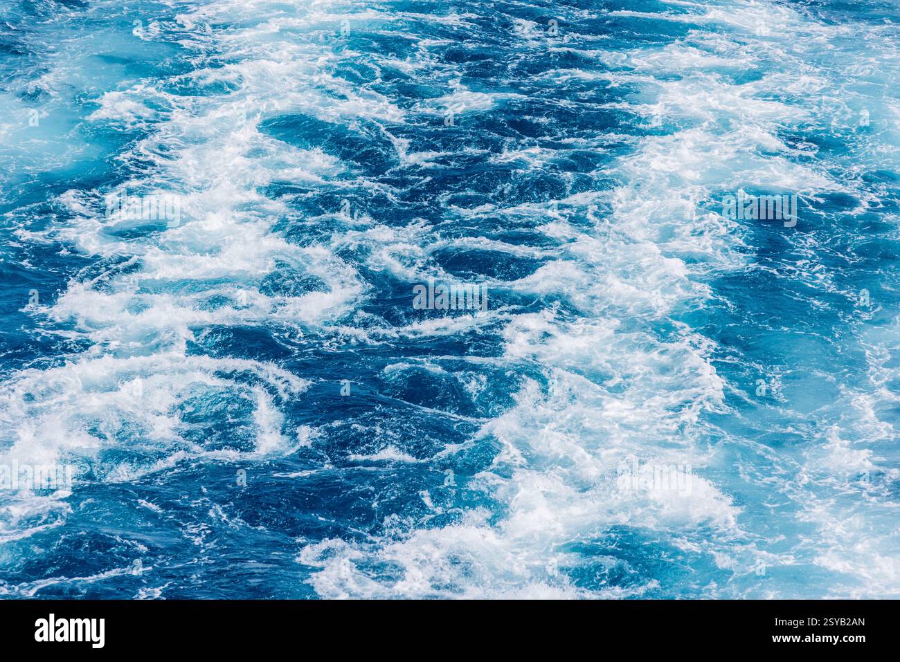 Turbulent sea waves with foam and ripples in deep blue water. The ...