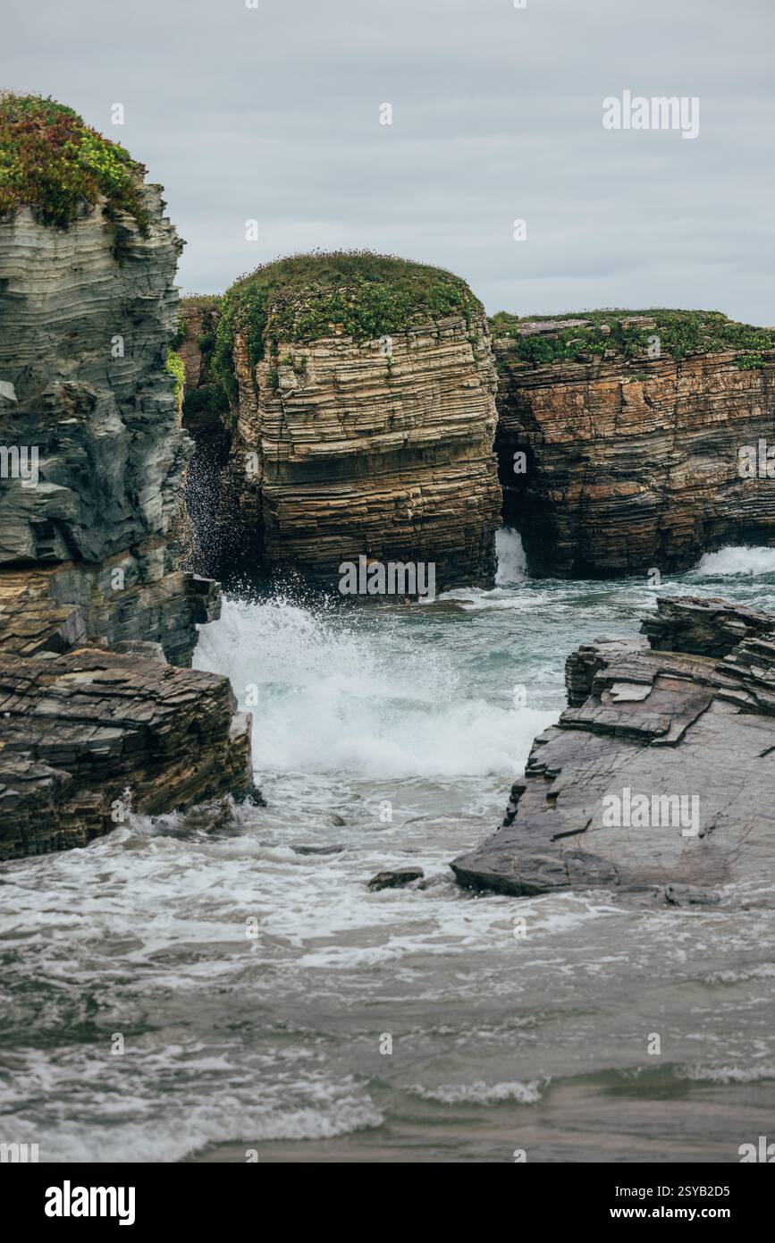 The rugged cliffs of Galicia's coast rise above the crashing waves of ...