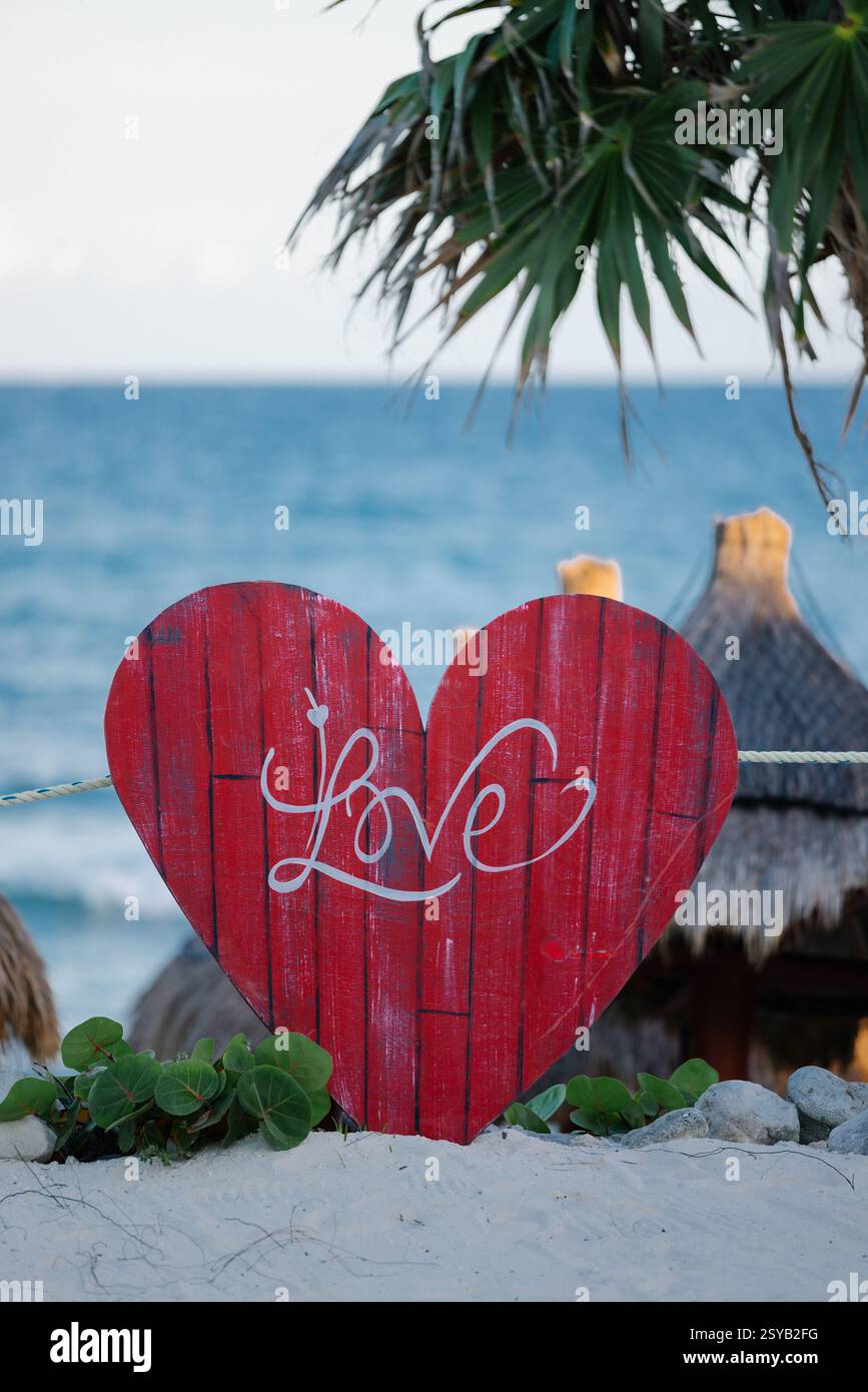 A vibrant red heart with "Love" inscribed, set against the serene ...