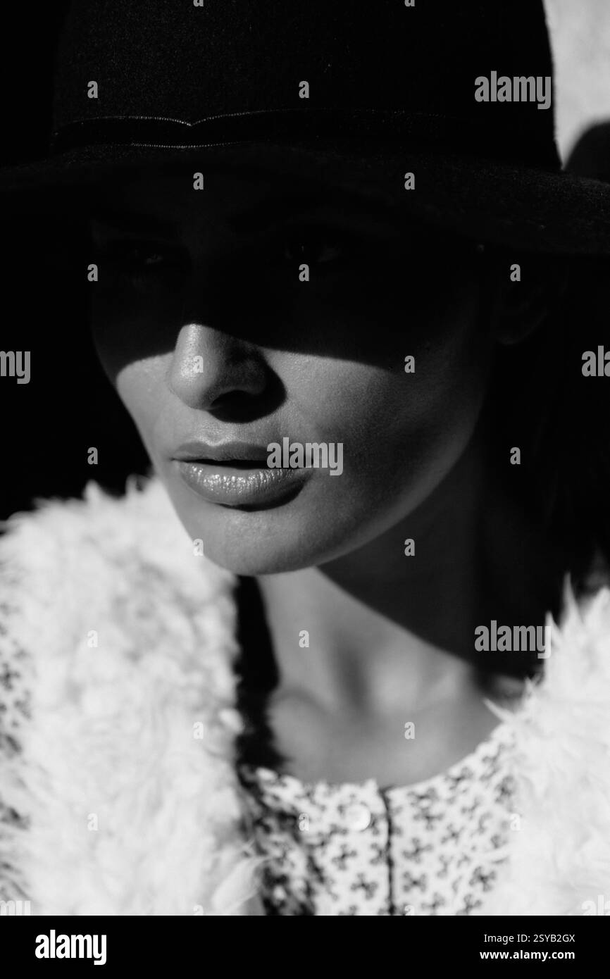 Black and white portrait of a woman wearing a broad-brimmed hat ...