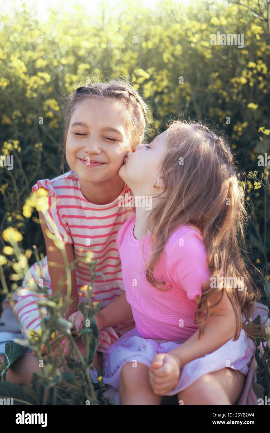A heartwarming moment between two young sisters as the little one gives ...