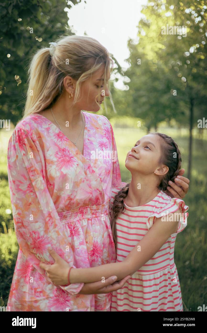 A mother and her daughter gaze at each other with love and ...