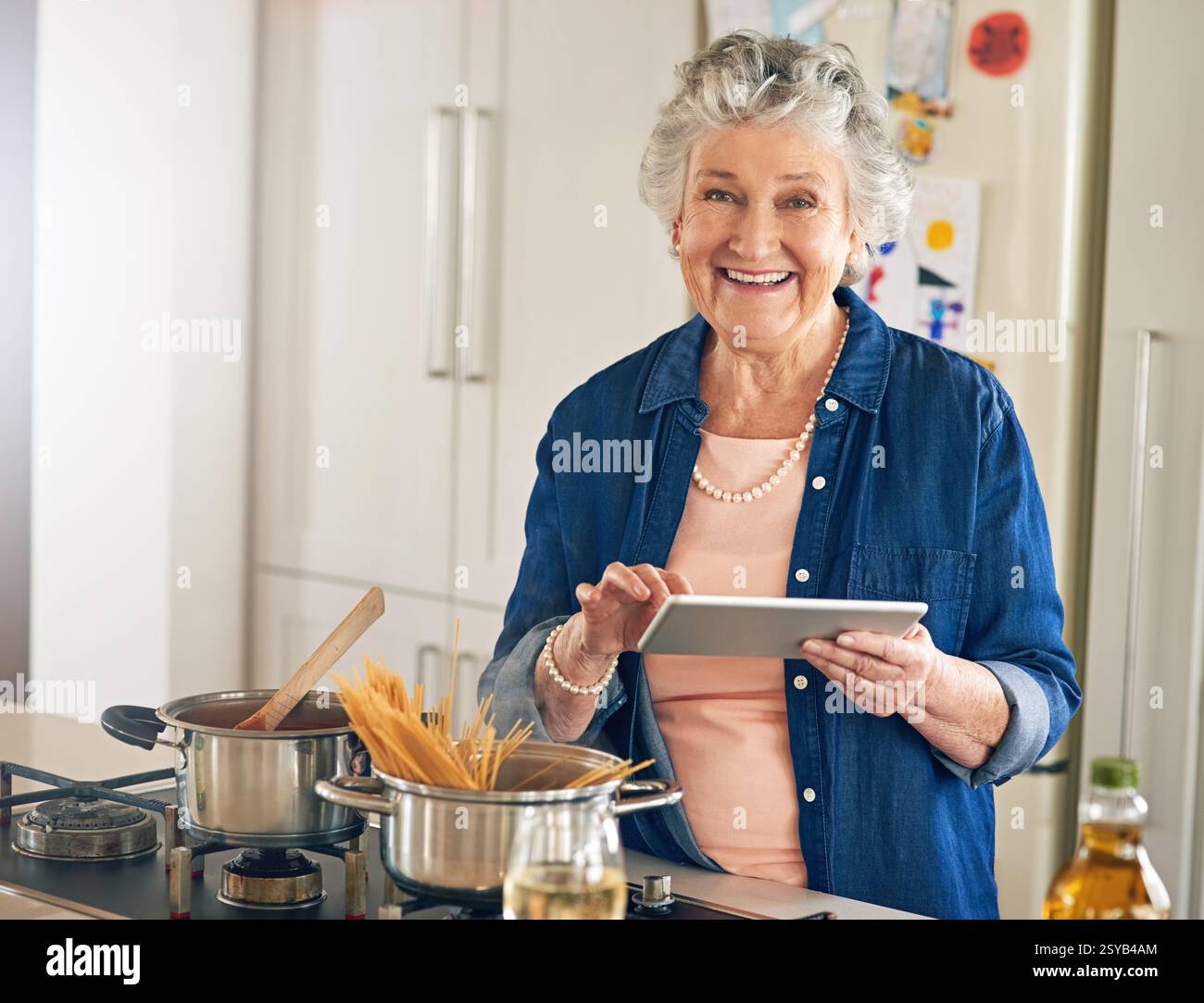 Portrait, senior woman and cooking with tablet in kitchen for recipe ...