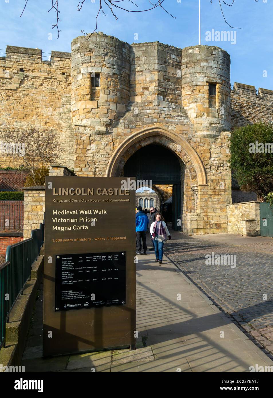 People outside entrance gateway to Lincoln castle, city of Lincoln ...