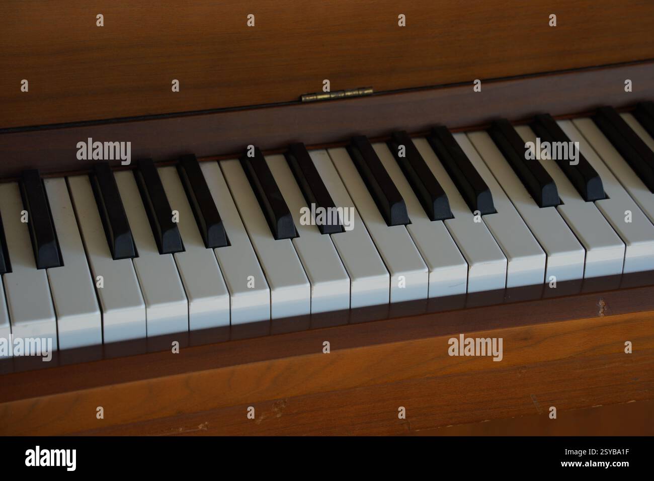 Keyboard of antique oak upright piano Stock Photo - Alamy