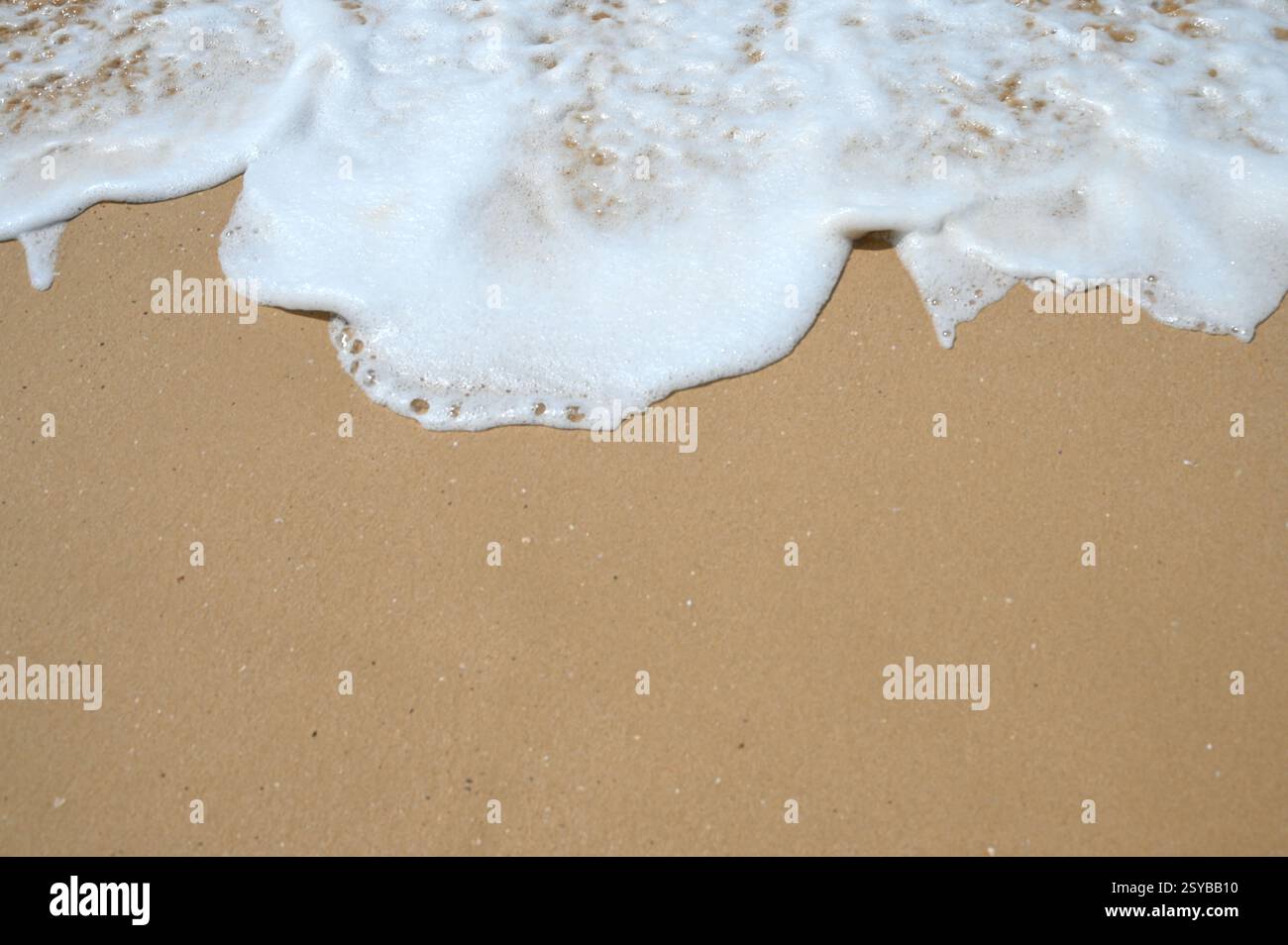 Gorgeous lacy ocean wave is surfing on sandy beach Stock Photo - Alamy