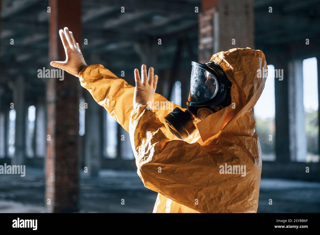 Nuclear explosion. Man dressed in chemical protection suit in the ruins ...