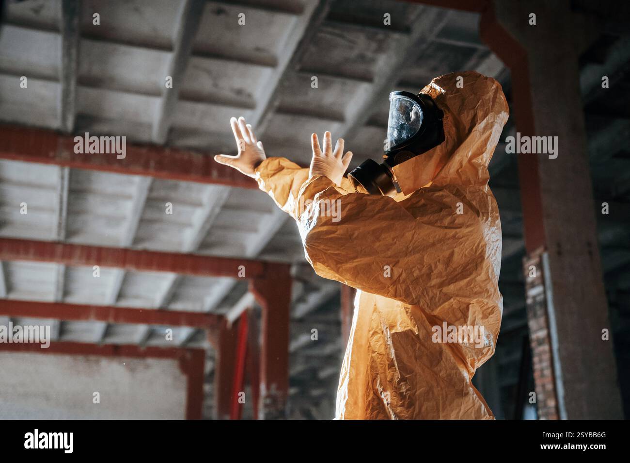 Nuclear explosion. Man dressed in chemical protection suit in the ruins ...