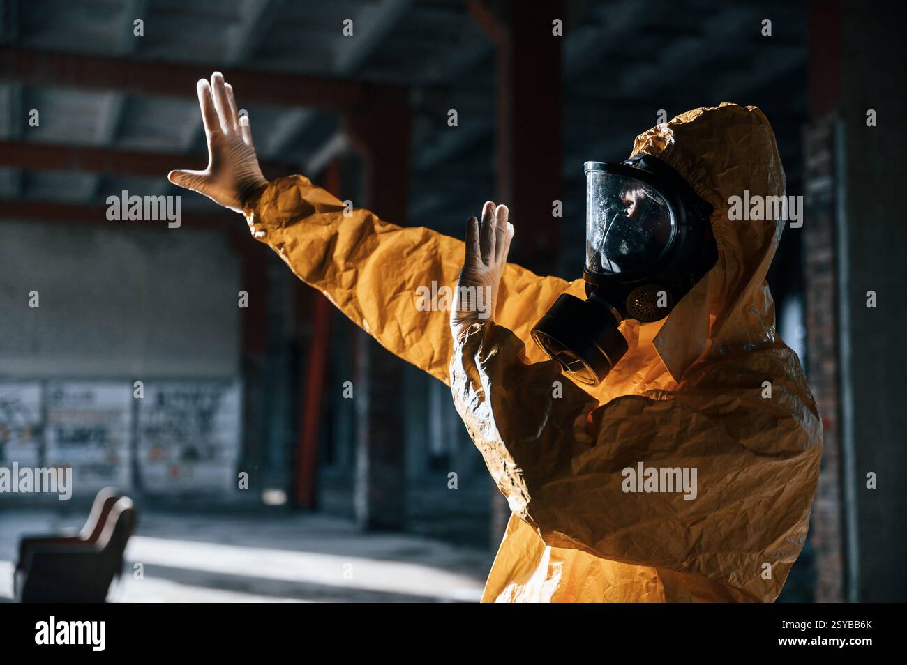 Nuclear explosion. Man dressed in chemical protection suit in the ruins ...